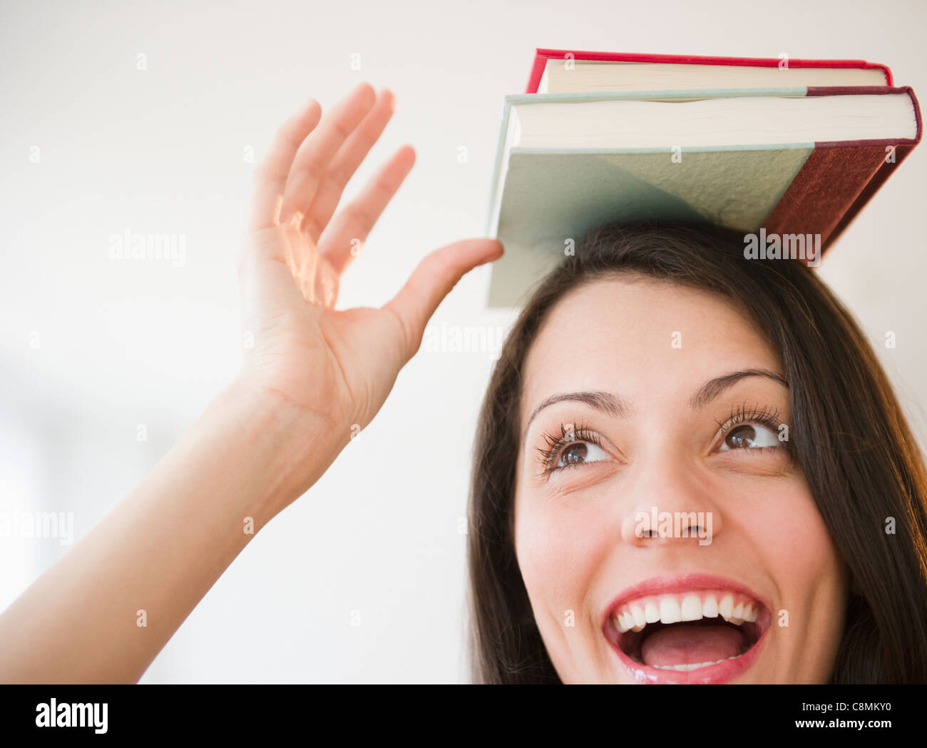 Woman balancing books head hi-res stock photography and images - Alamy