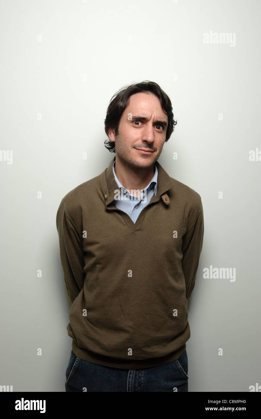 Portrait of young man looking suspiciously at camera Stock Photo - Alamy