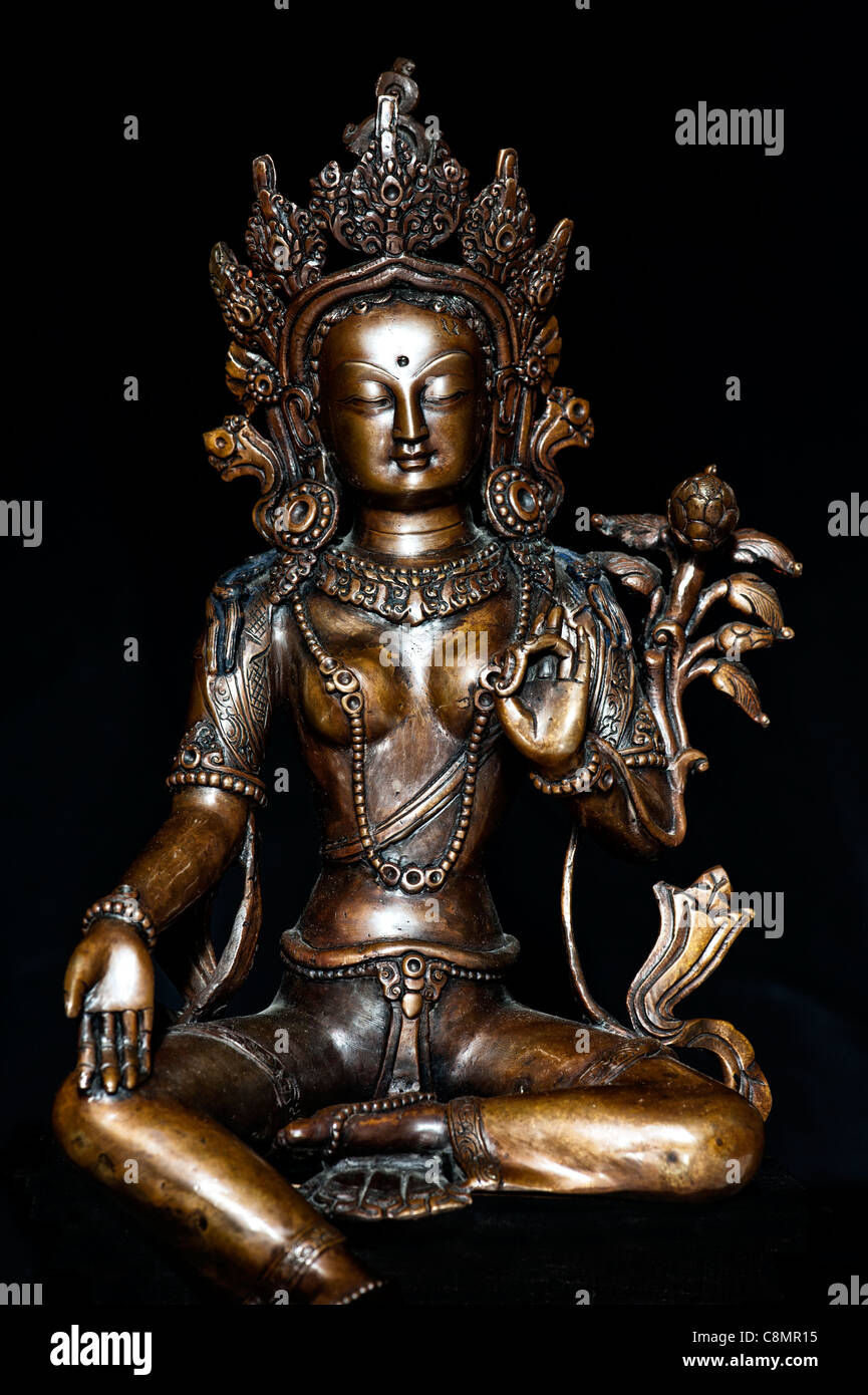 Green Tara Statue. Buddhist deity statue on black background Stock ...