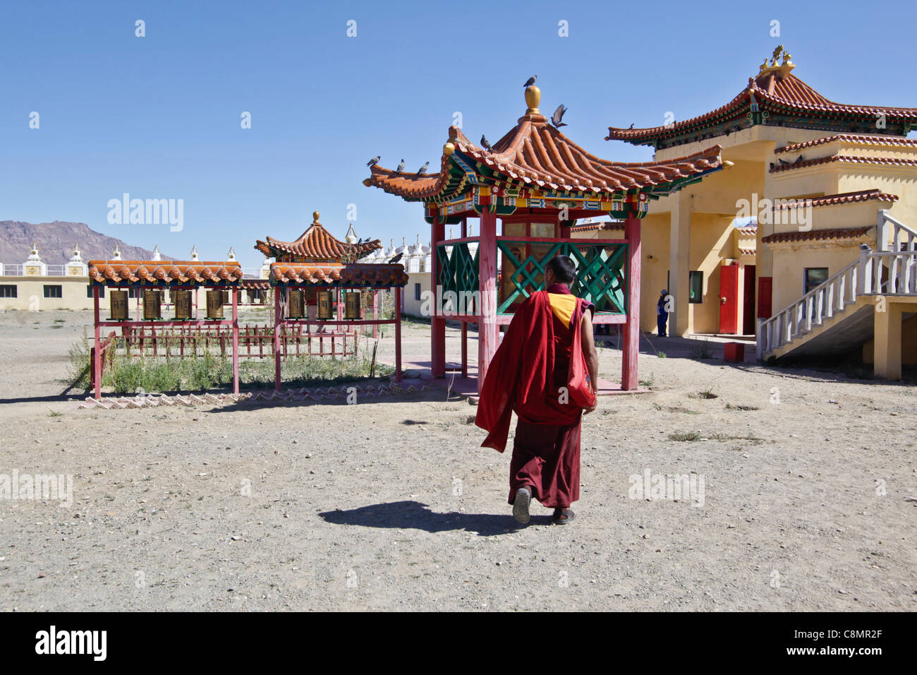 Buddhist monk walking across the grounds of a Monastery in Mongolia ...