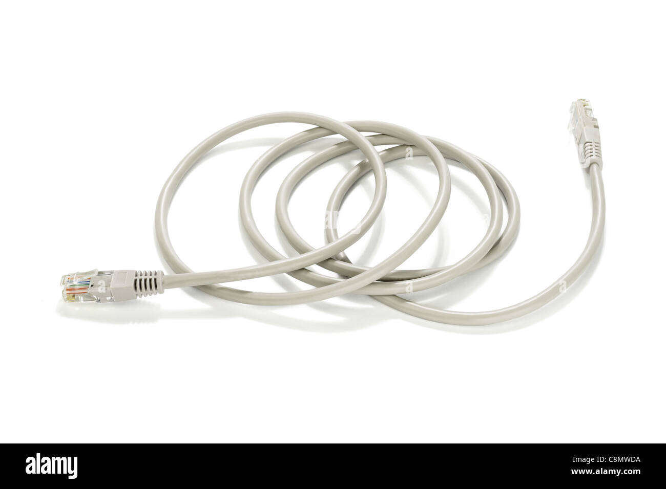 Network cable and plugs lying on white background Stock Photo - Alamy