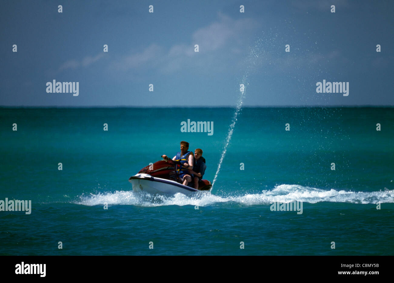 Dickenson Bay Antigua Father And Son On Jet Ski Stock Photo - Alamy