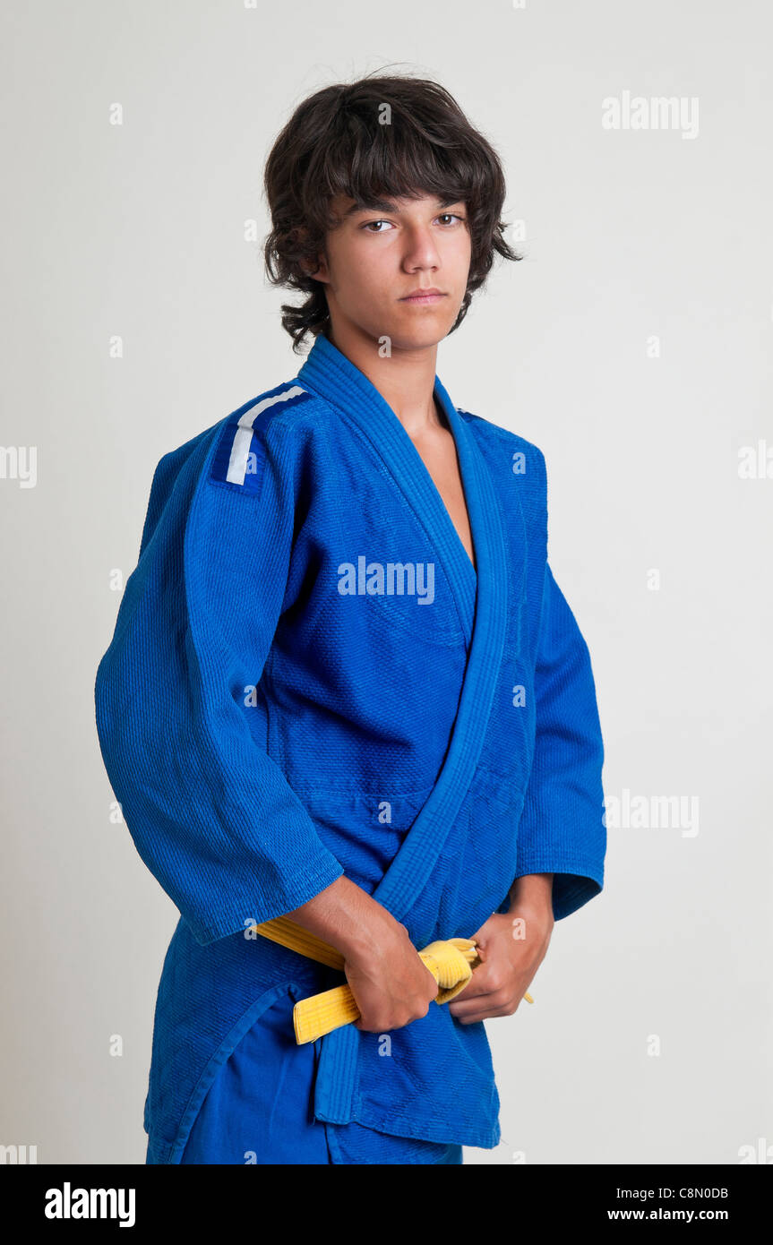 Young fighter posing against a light background Stock Photo - Alamy