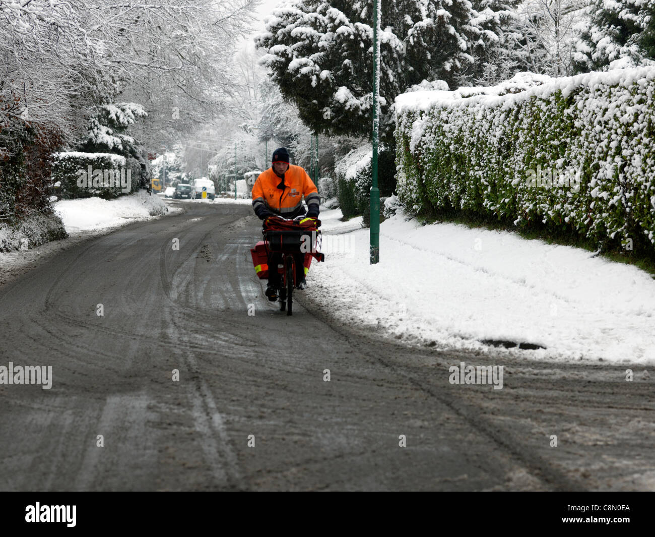 Postman Riding a Bicycle In The Snow Surrey England Stock Photo - Alamy