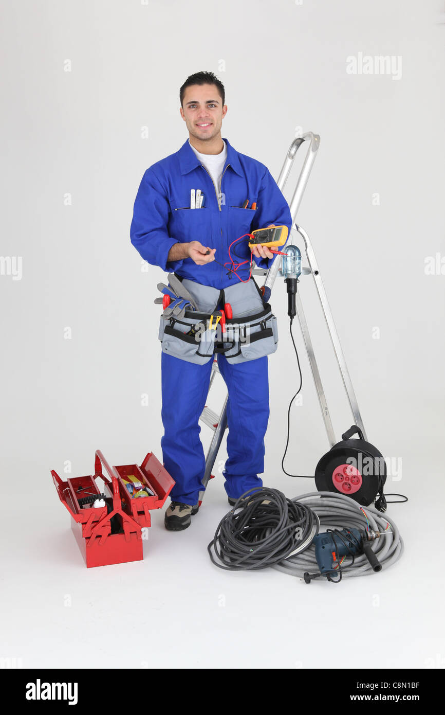 Handyman holding a multimeter Stock Photo - Alamy