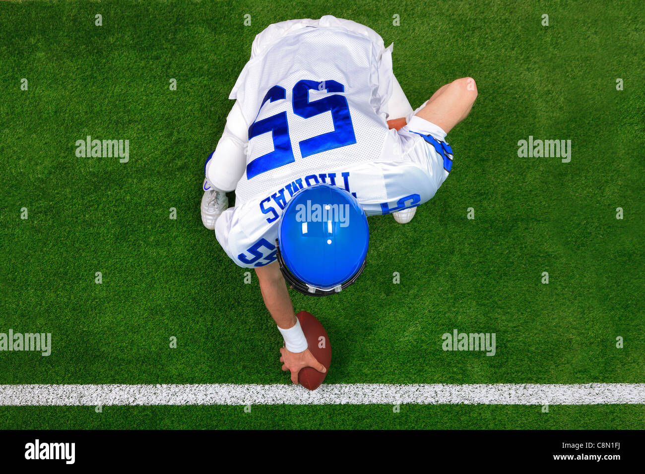 Overhead photo of an American football player center offense about to ...
