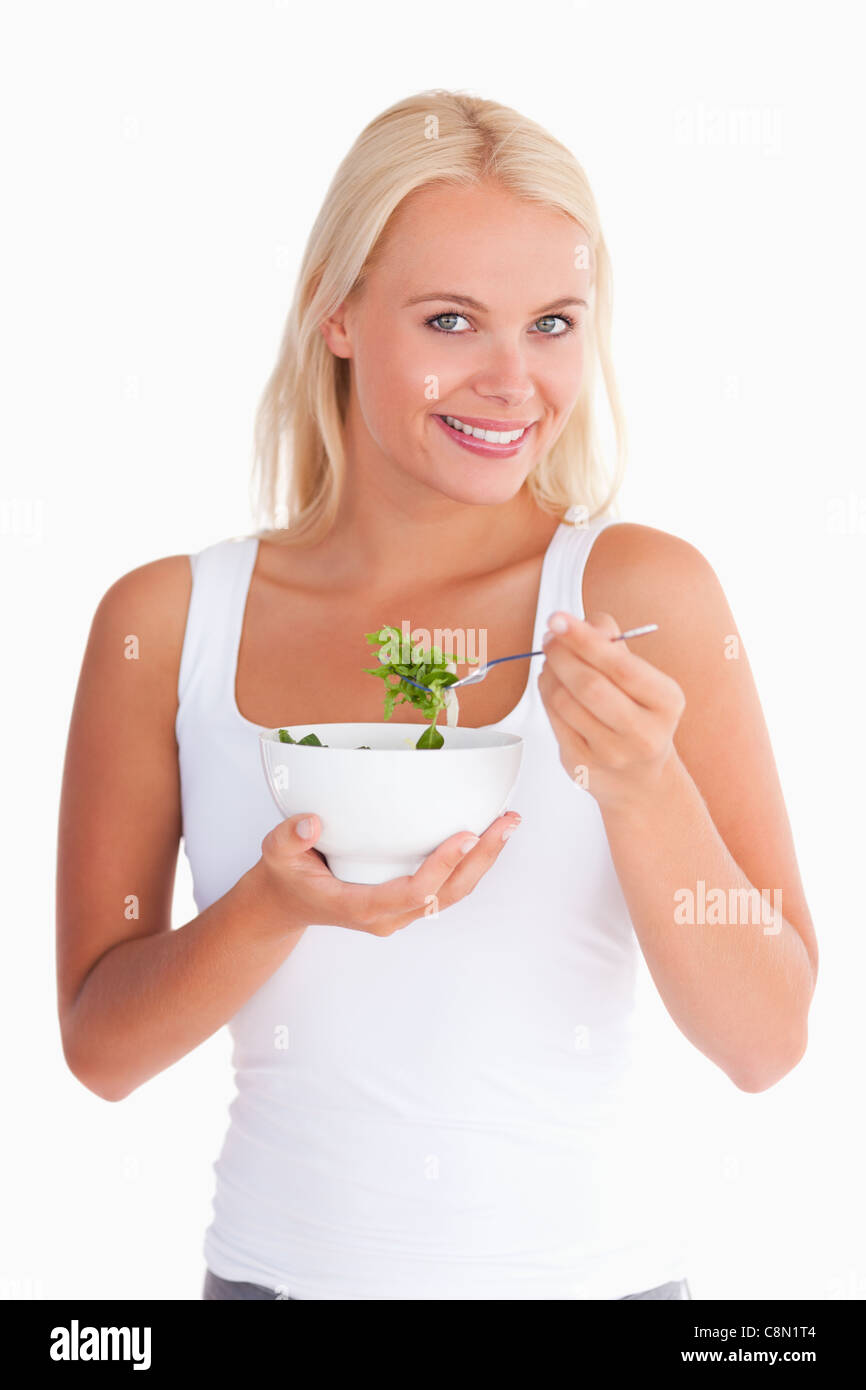 Smiling lady eating salad Stock Photo - Alamy