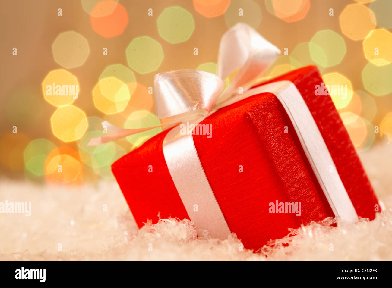 A Christmas box in snow against glaring background Stock Photo - Alamy