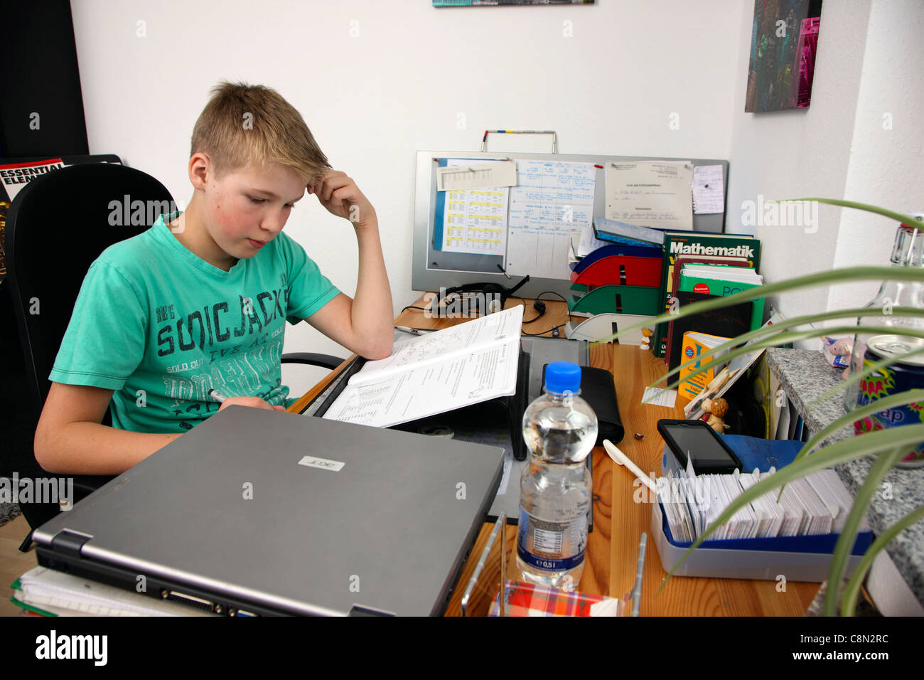 Boy 13 years doing homework hi-res stock photography and images - Alamy