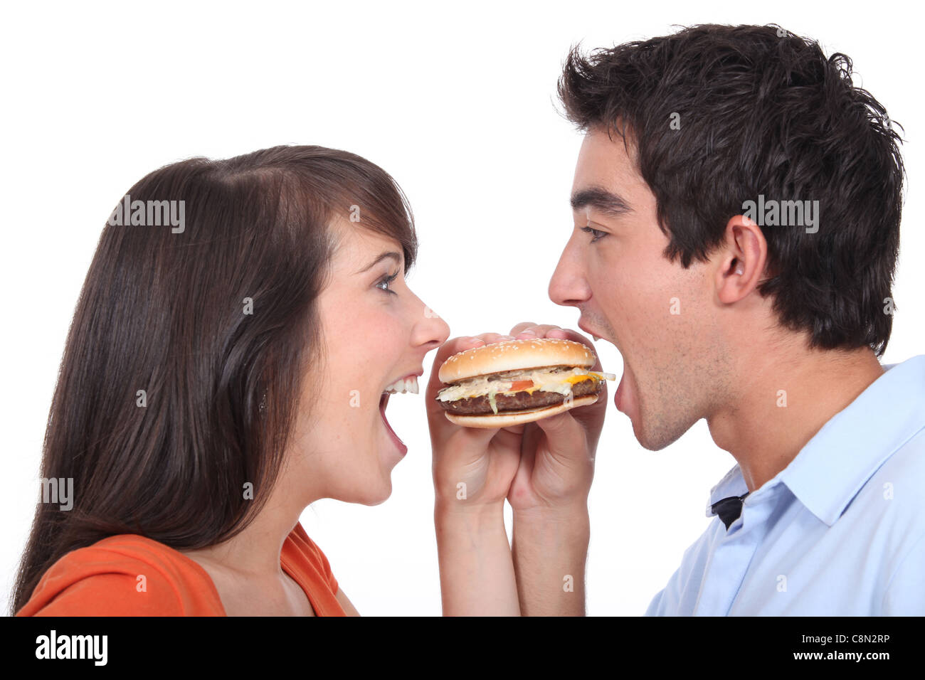 young people eating hamburger Stock Photo - Alamy