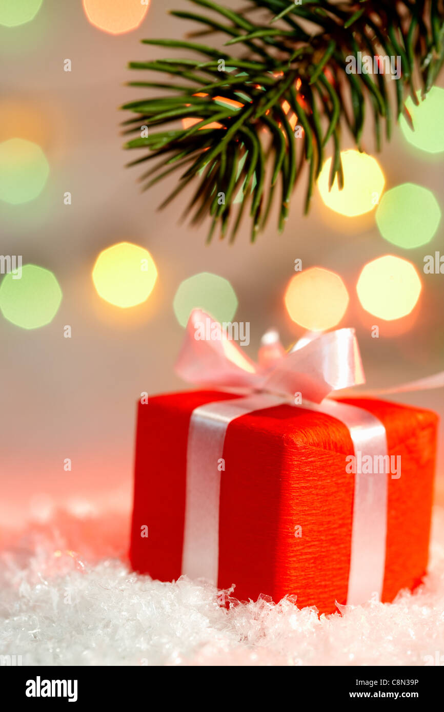 A Christmas box in snow against glaring background Stock Photo - Alamy