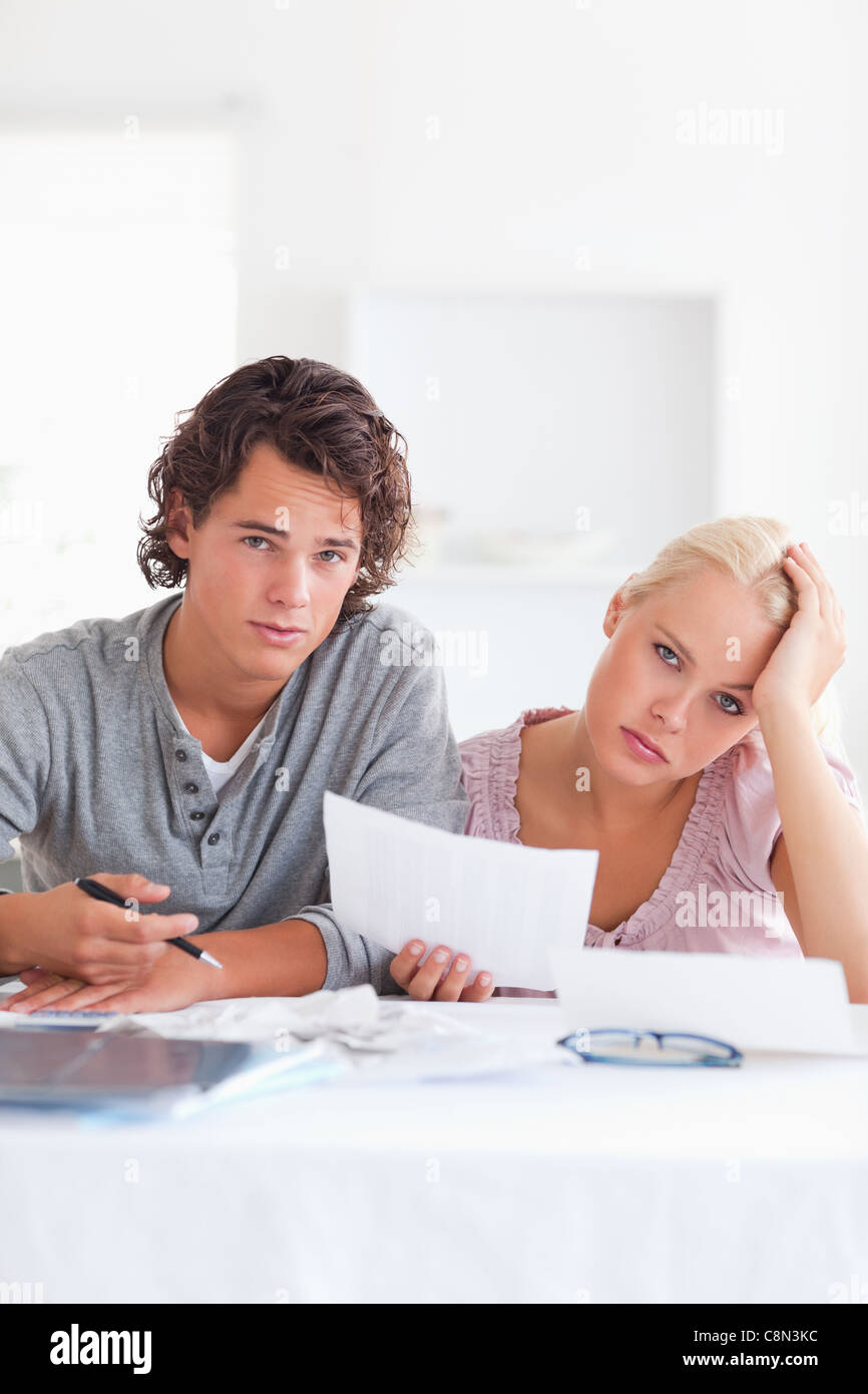 Unhappy couple reading a letter Stock Photo - Alamy