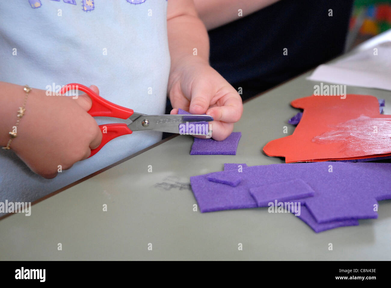 Nursery child learning how to use a pair of scissors at nursery Stock ...