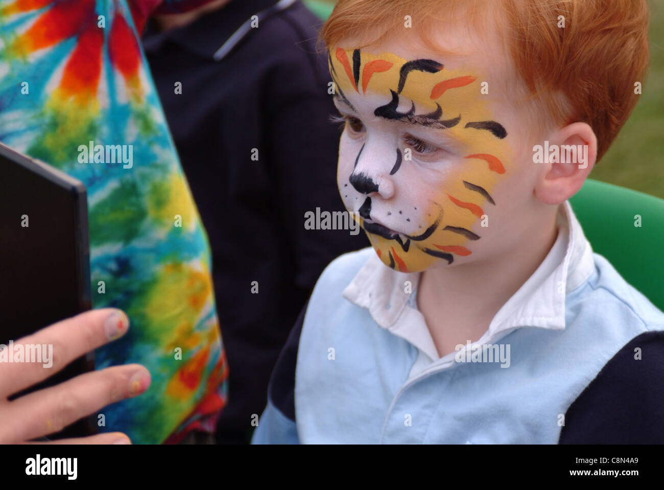 Little boy having his face painted Stock Photo - Alamy