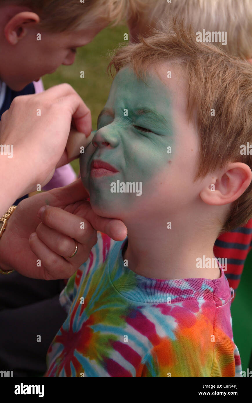 Little Boy having his face painted Stock Photo - Alamy