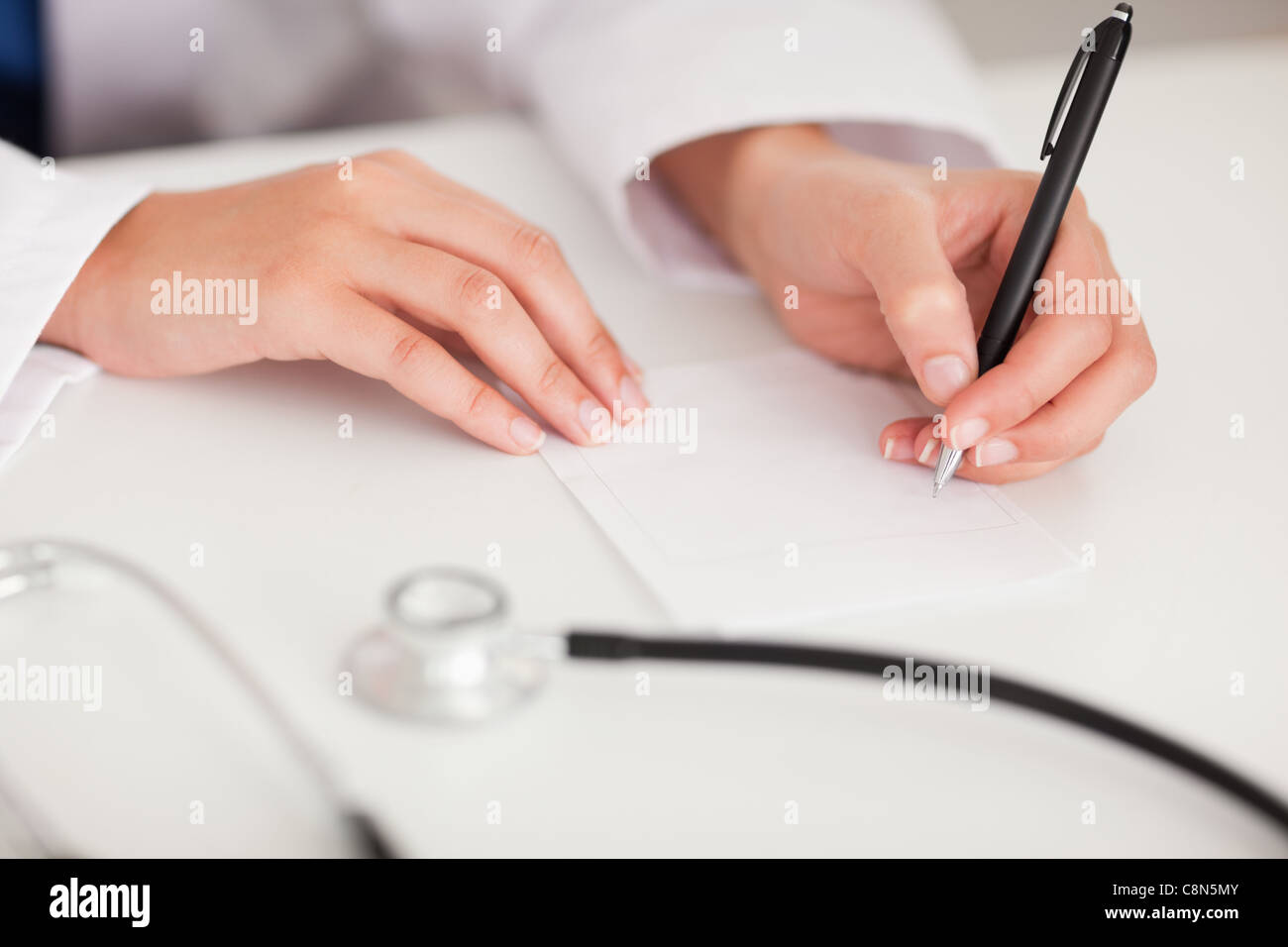 Doctor writing a note Stock Photo - Alamy