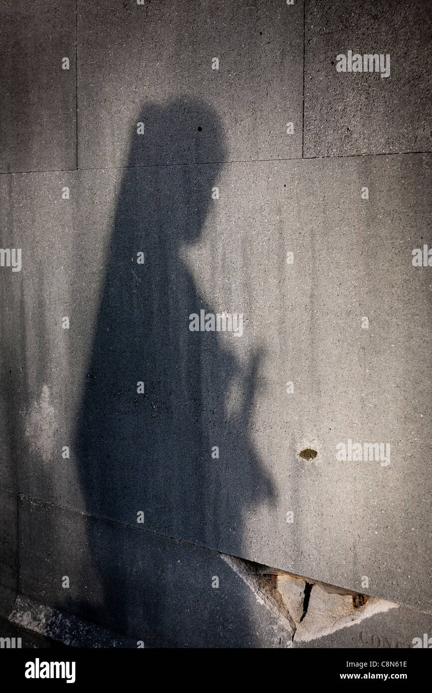 Shadow of statue cast onto side of tomb at Montmartre Cemetery, Paris ...