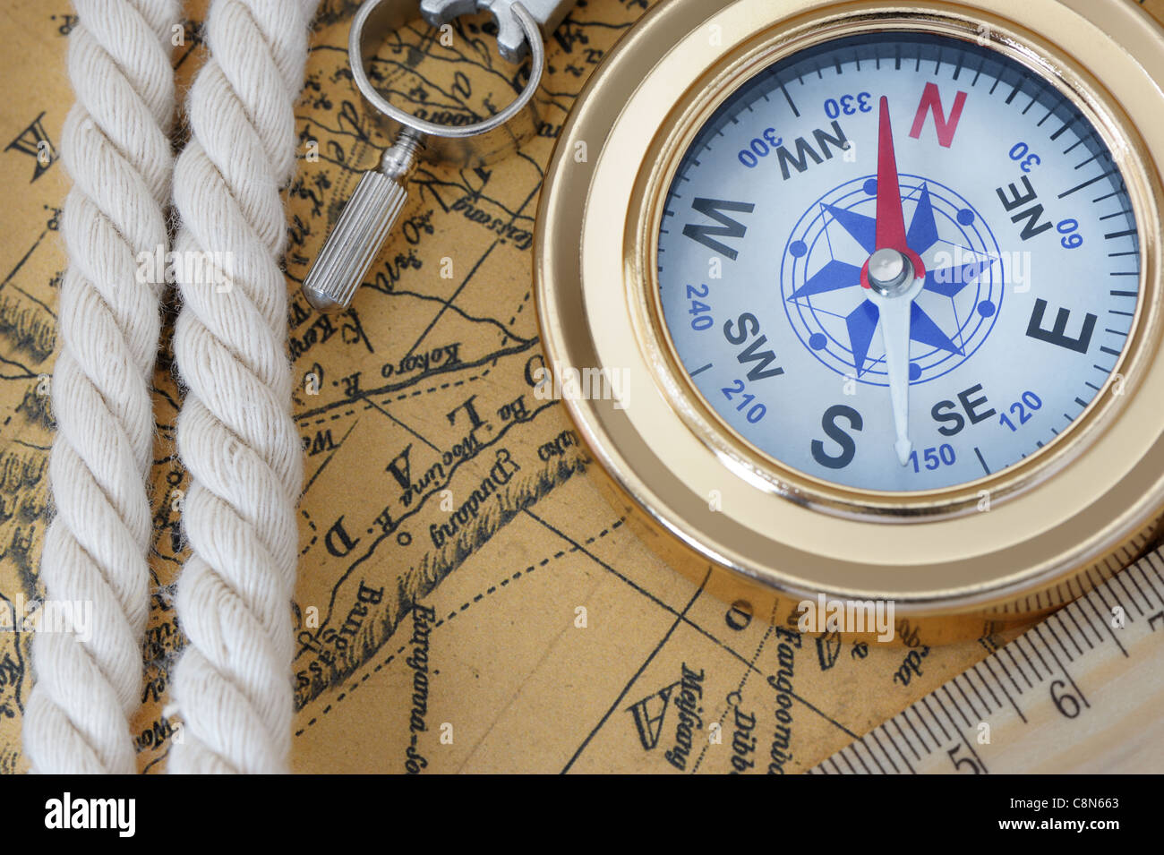 Travel object. Old map, a rope, a compass Stock Photo - Alamy