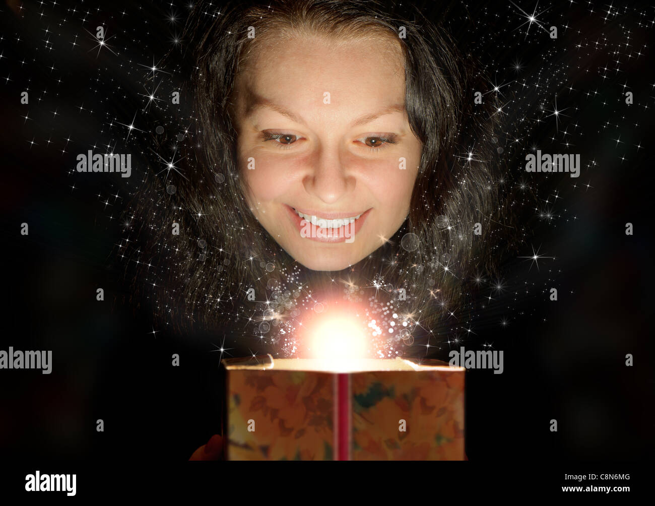 The woman with abstract light from a gift box. Emotion a surprise. A ...