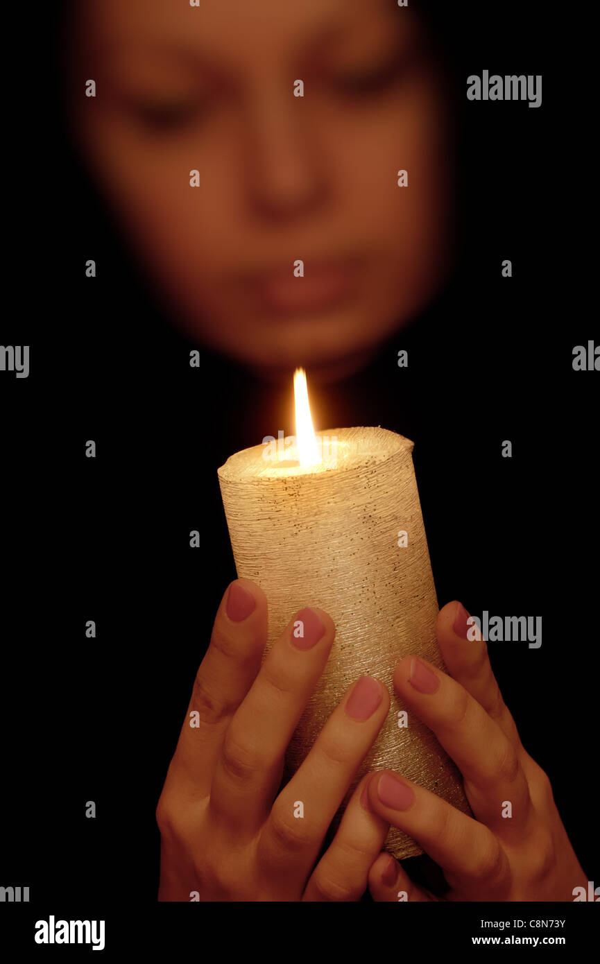 The woman with burning candle. Selective focus on a candle Stock Photo ...