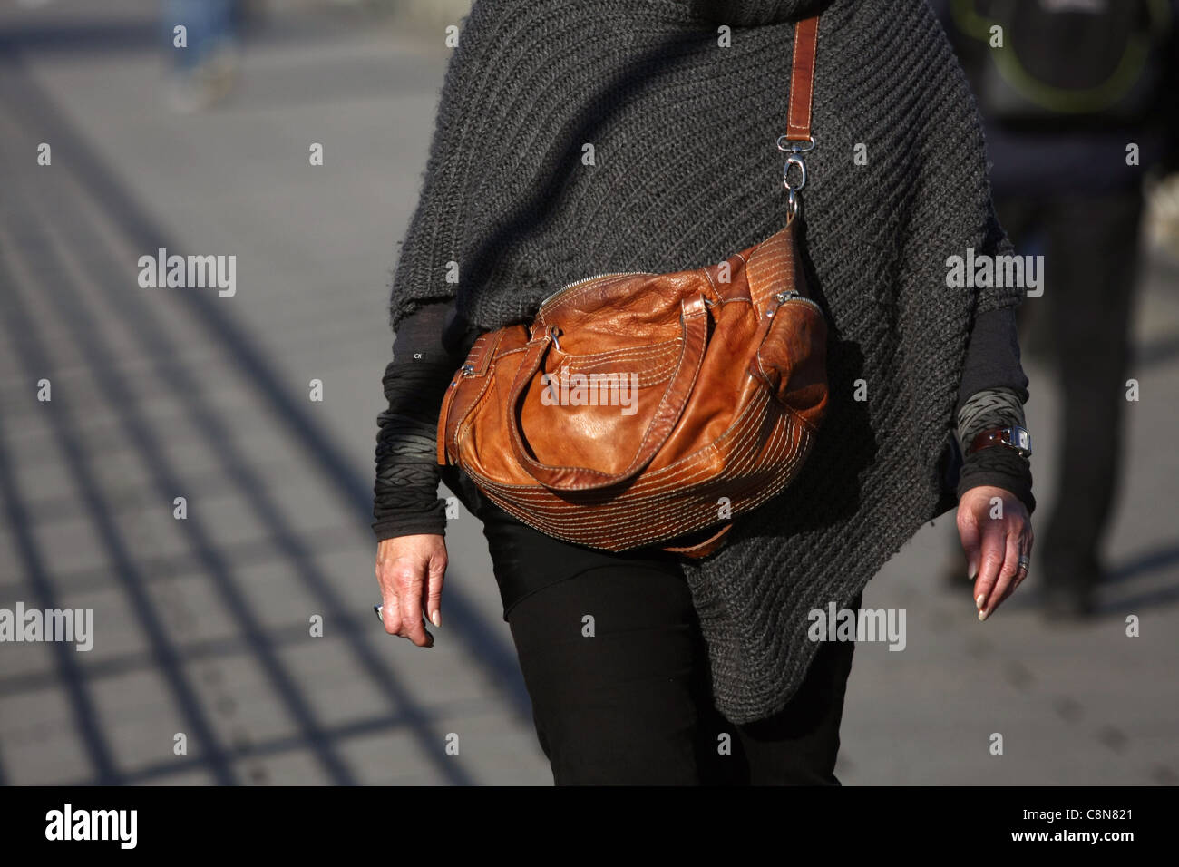 Front view of a shoulder bag being carried by a female wearing a woolen ...