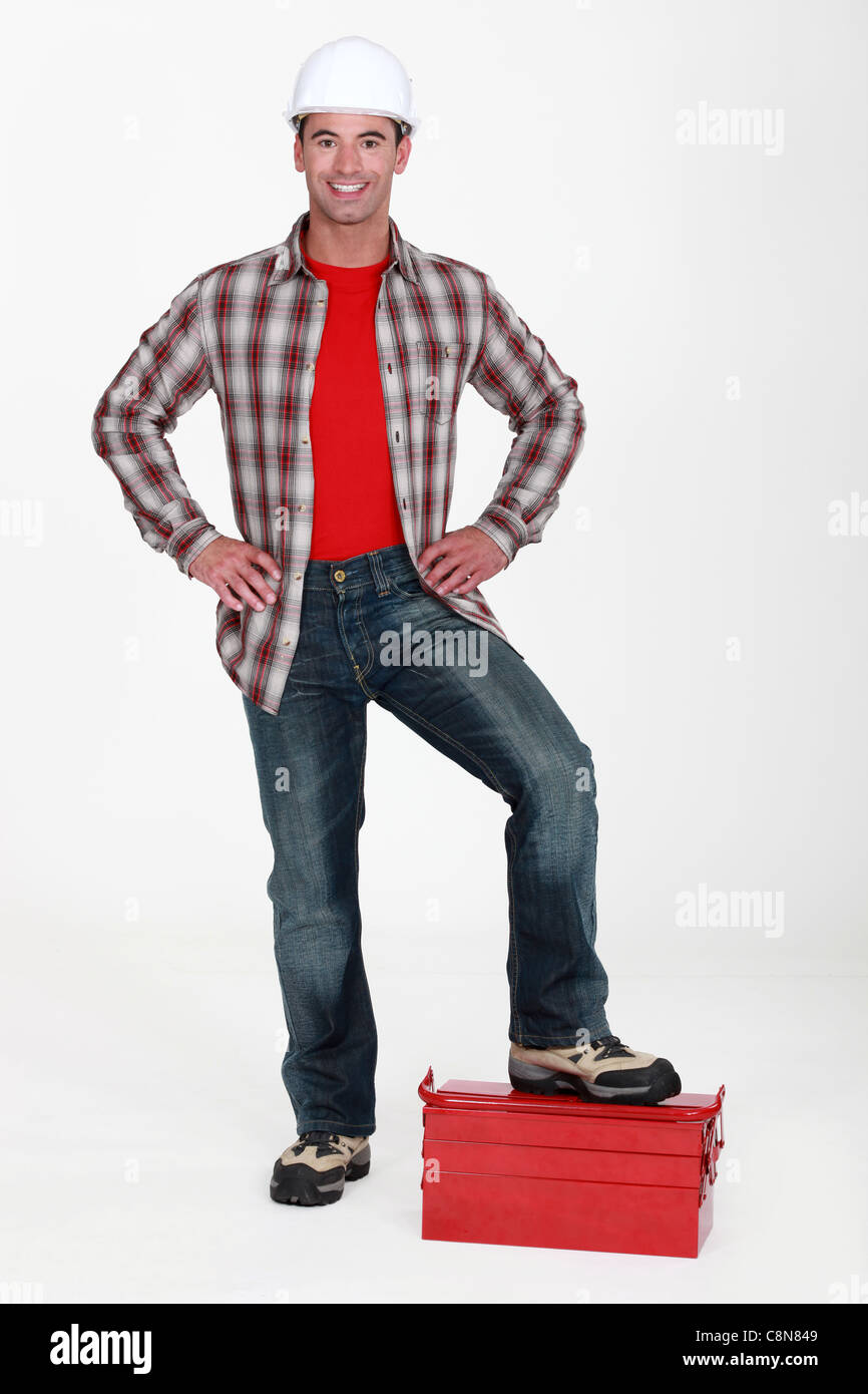 Male builder stood on toolbox Stock Photo - Alamy