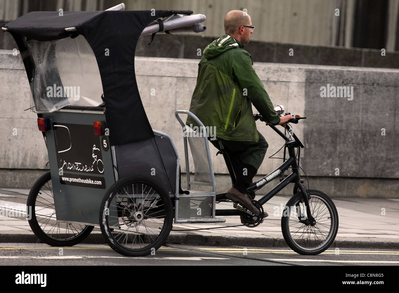 a man cycling a rickshaw in London Stock Photo - Alamy
