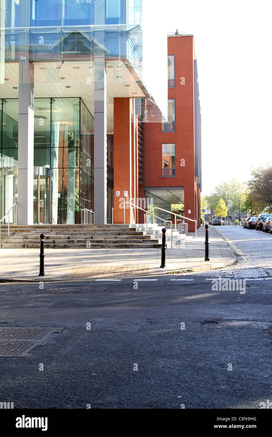 Outside an office block, paved sidewalk that passes under the buildings ...