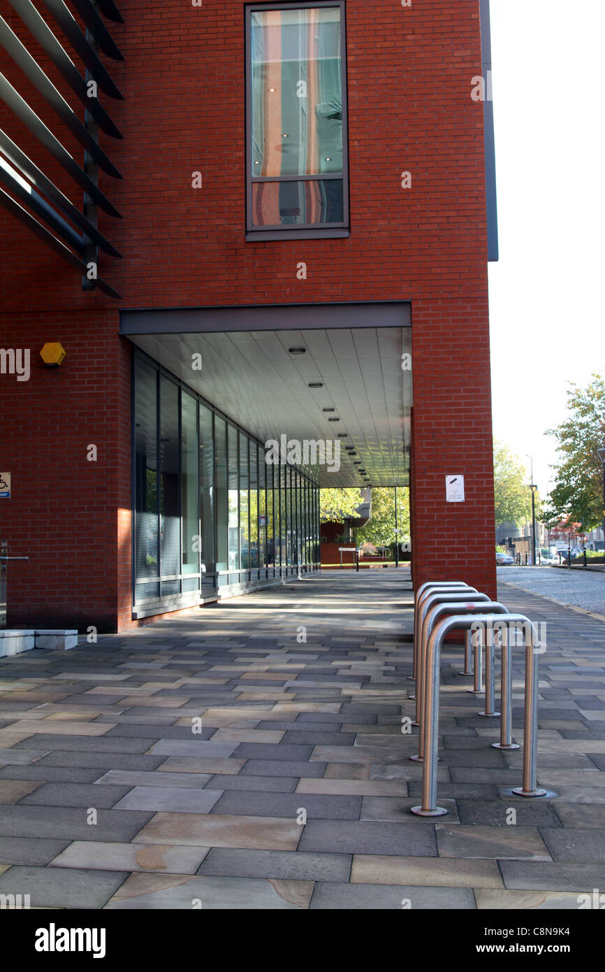 Outside an office block, paved sidewalk that passes under the buildings ...