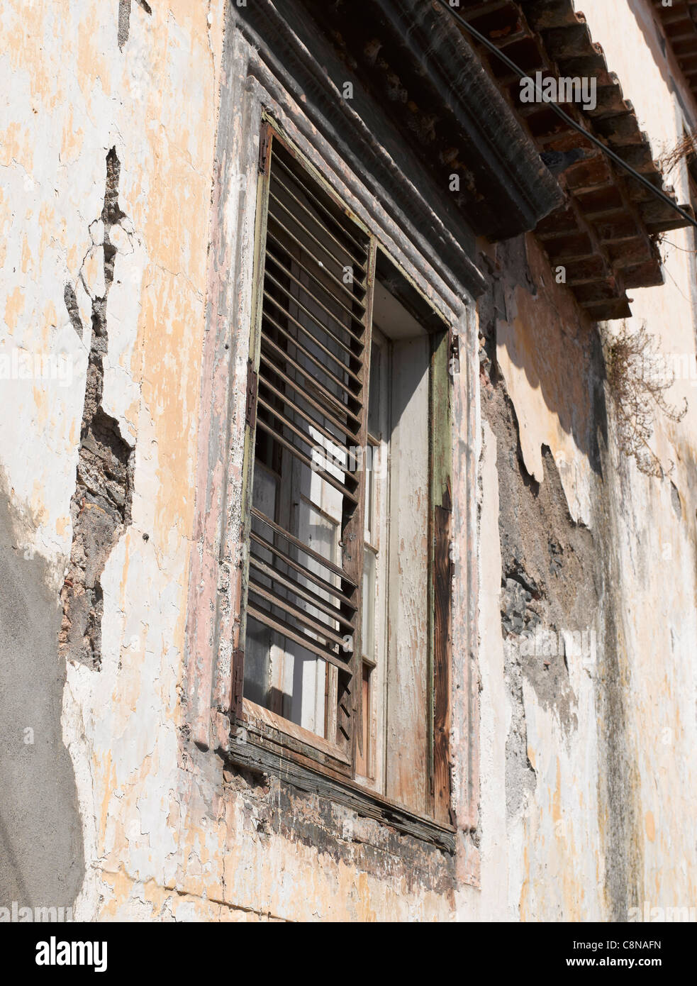 Close up of broken window shutter on a old derelict building Funchal ...