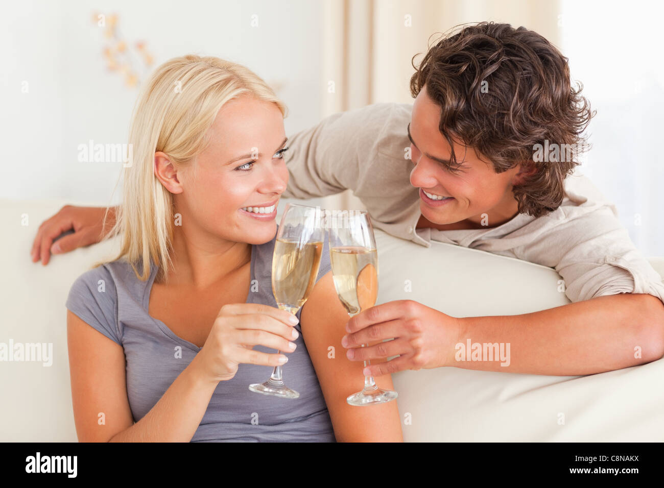 Young couple making a toast Stock Photo - Alamy