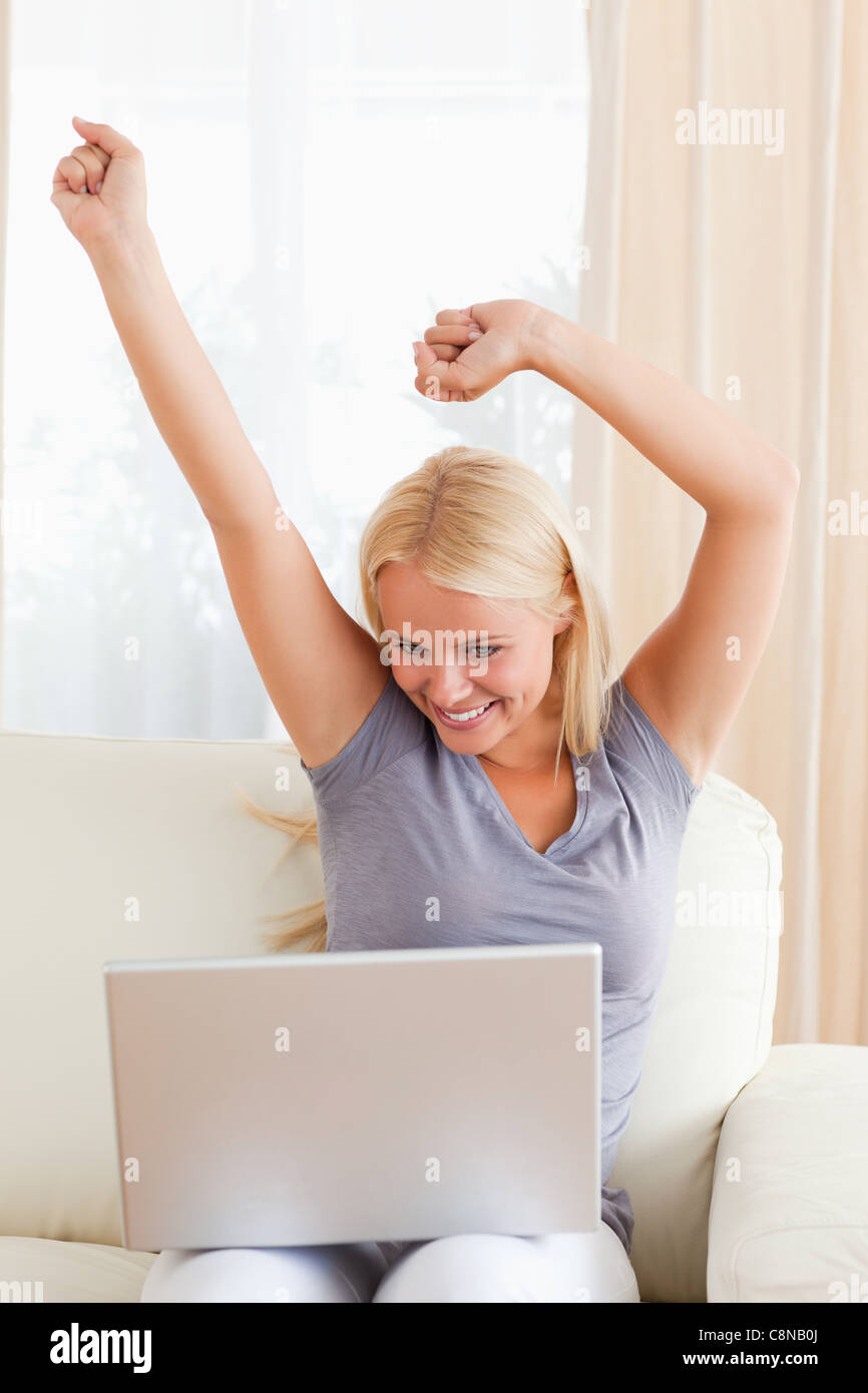 Portrait of an excited woman using a laptop Stock Photo - Alamy