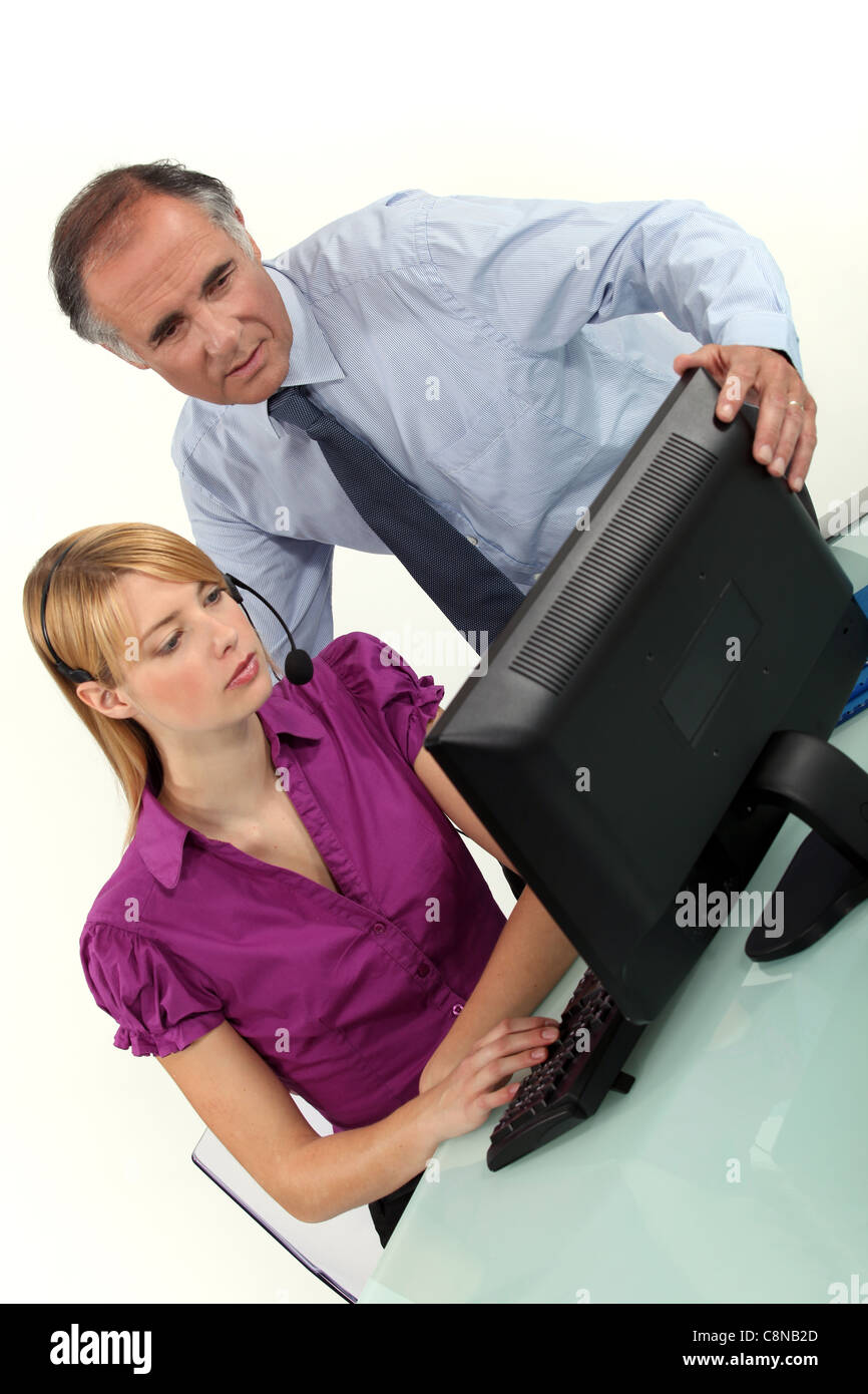 businessman and secretary looking at the computer Stock Photo - Alamy