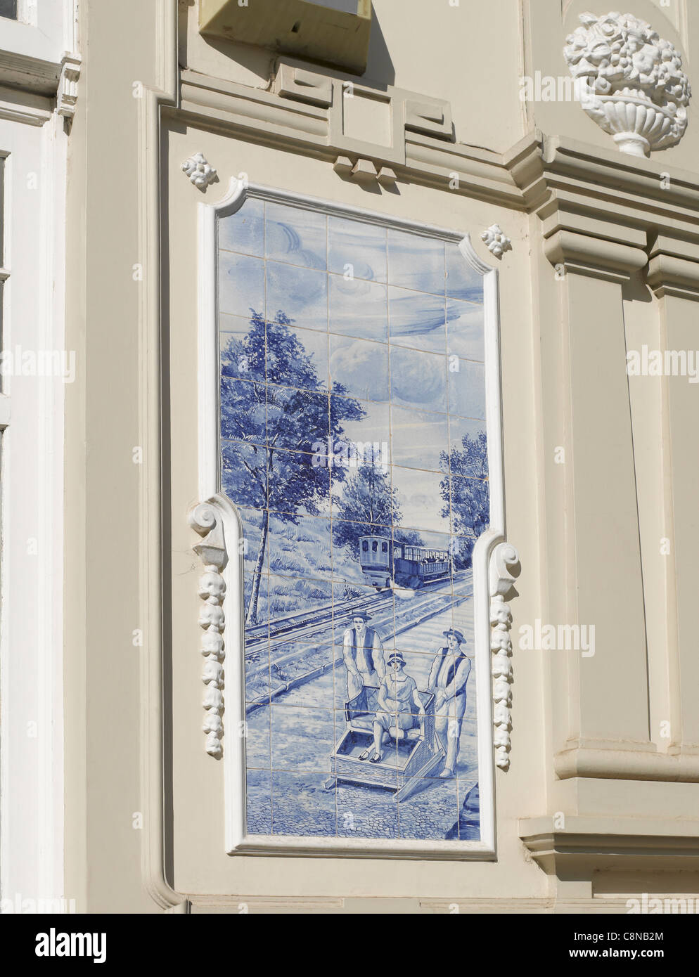 Close up of decorative tiles showing Monte railway and taboggan sledge ...