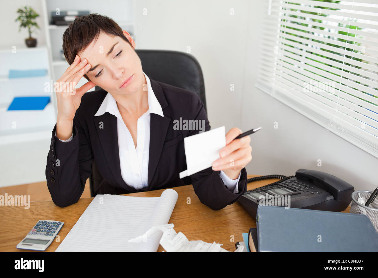 Unhappy accountant checking receipts Stock Photo - Alamy