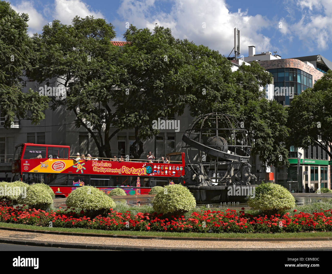Tourist tour open top bus at Rotunda Do Infante roundabout in the town ...