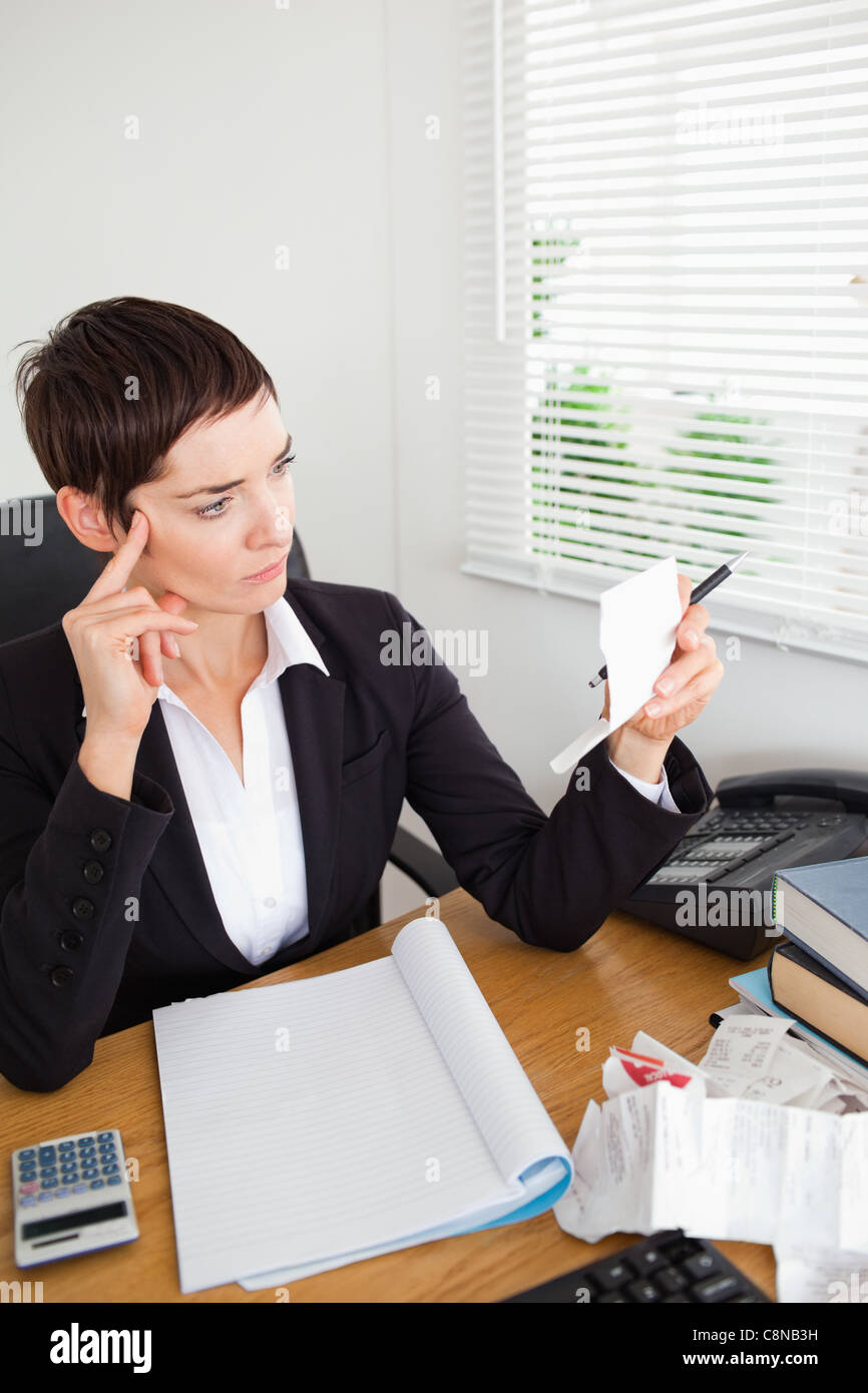 Focused accountant checking receipts Stock Photo - Alamy