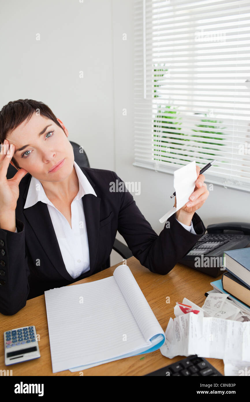 Cute accountant checking receipts Stock Photo - Alamy