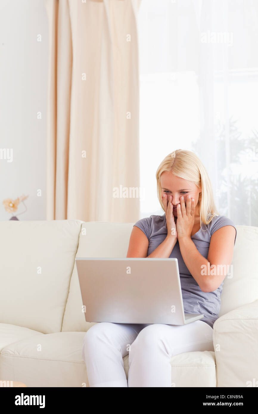 Sad woman using a laptop Stock Photo - Alamy
