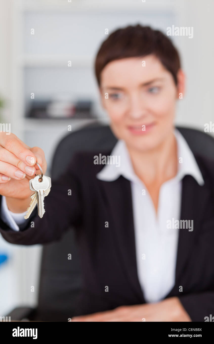 Portrait of a woman showing keys Stock Photo - Alamy