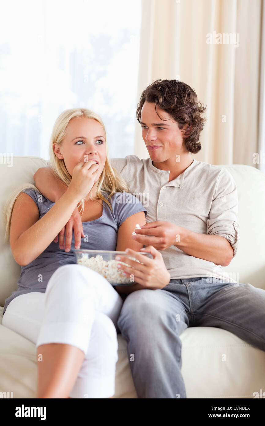 Portrait of a couple eating popcorn Stock Photo - Alamy