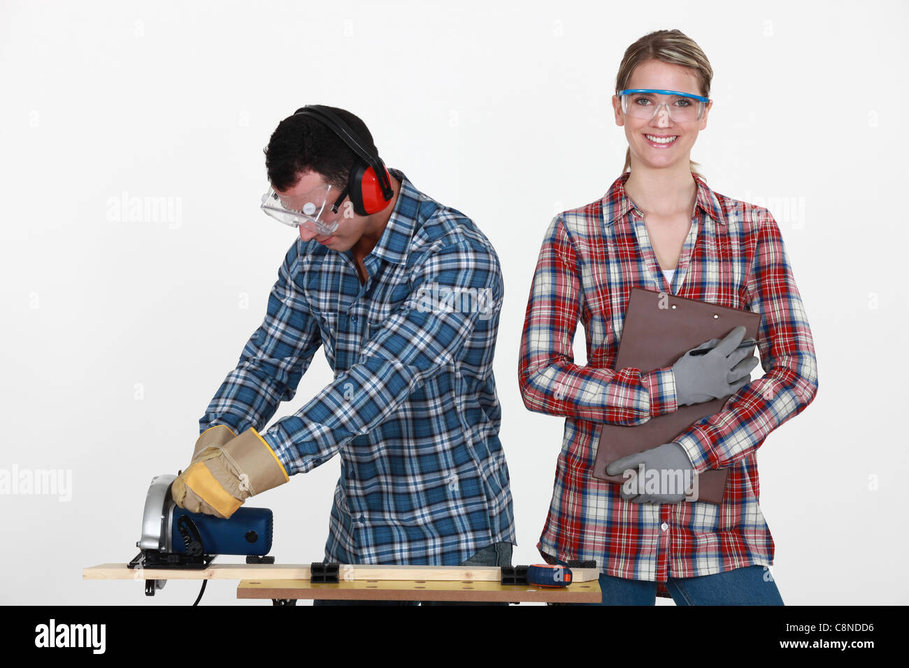 a man using a circular saw and a woman Stock Photo - Alamy