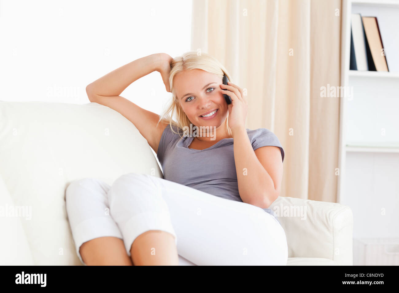 Happy blonde model making phone hi-res stock photography and images - Alamy