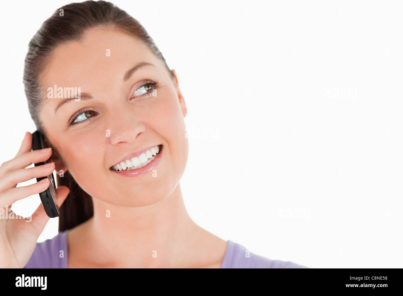Portrait of a cute woman on the phone while standing Stock Photo - Alamy