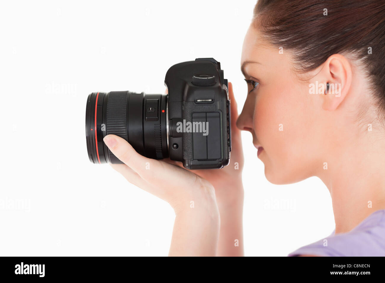 Attractive female using a camera while standing Stock Photo - Alamy