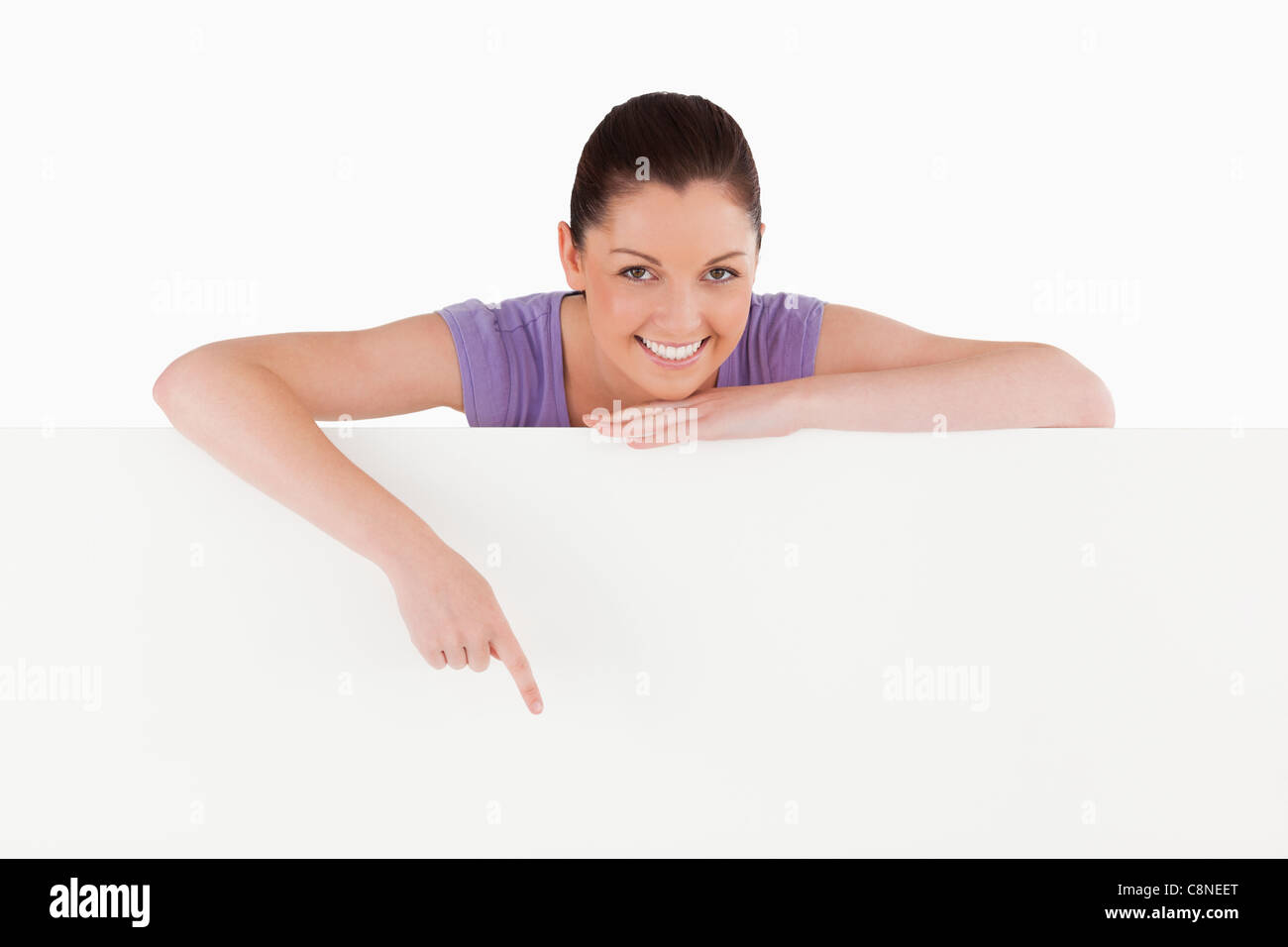 Pretty female pointing at a billboard Stock Photo - Alamy