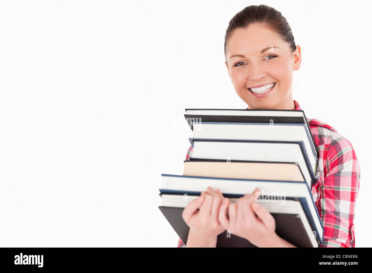 Gorgeous female posing with books while standing Stock Photo - Alamy