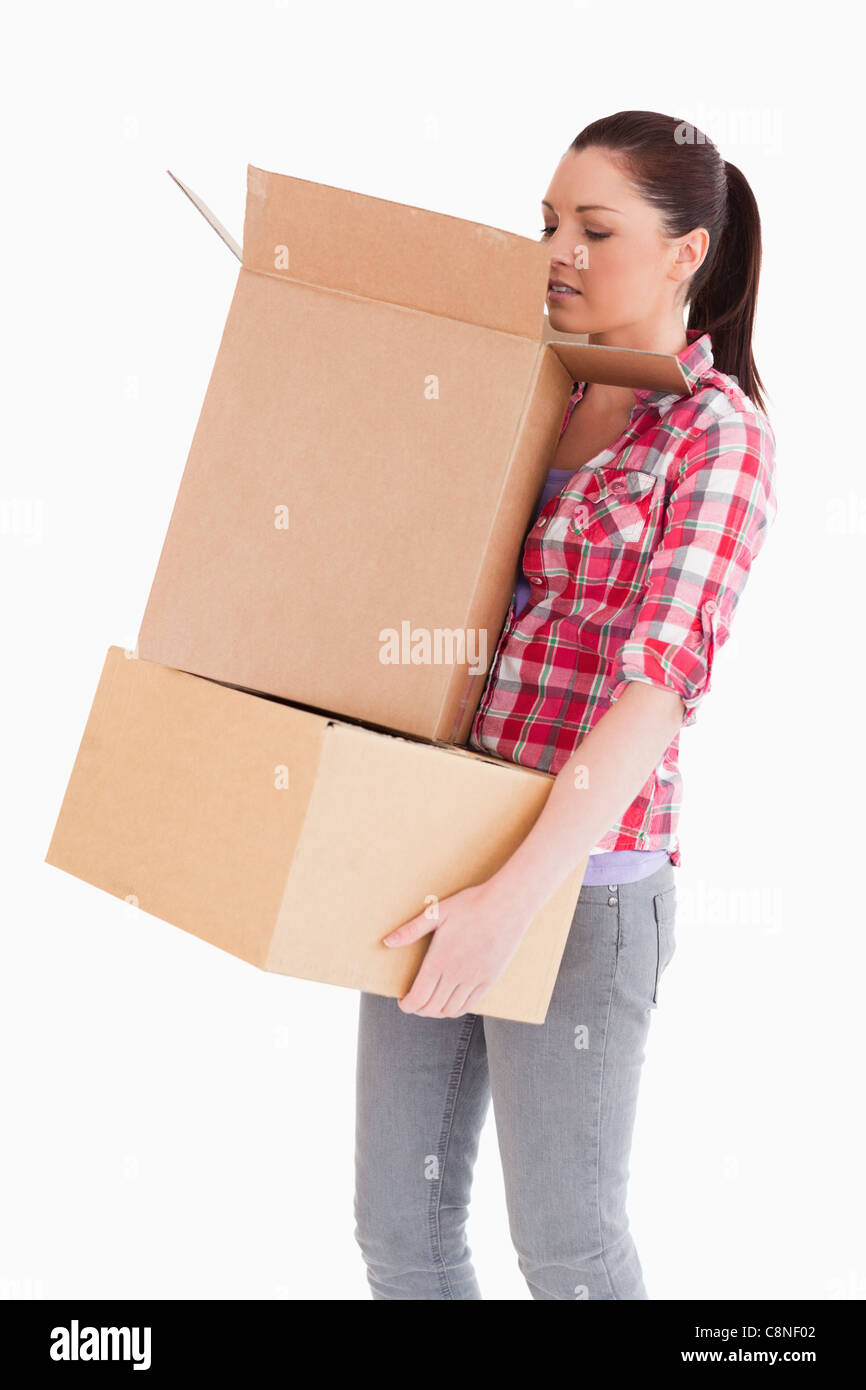 Beautiful woman looking inside a cardboard box while standing Stock ...