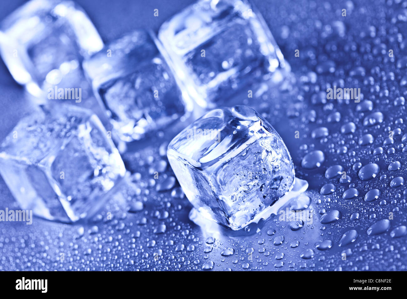 ice cubes and water drops on the blue background Stock Photo - Alamy