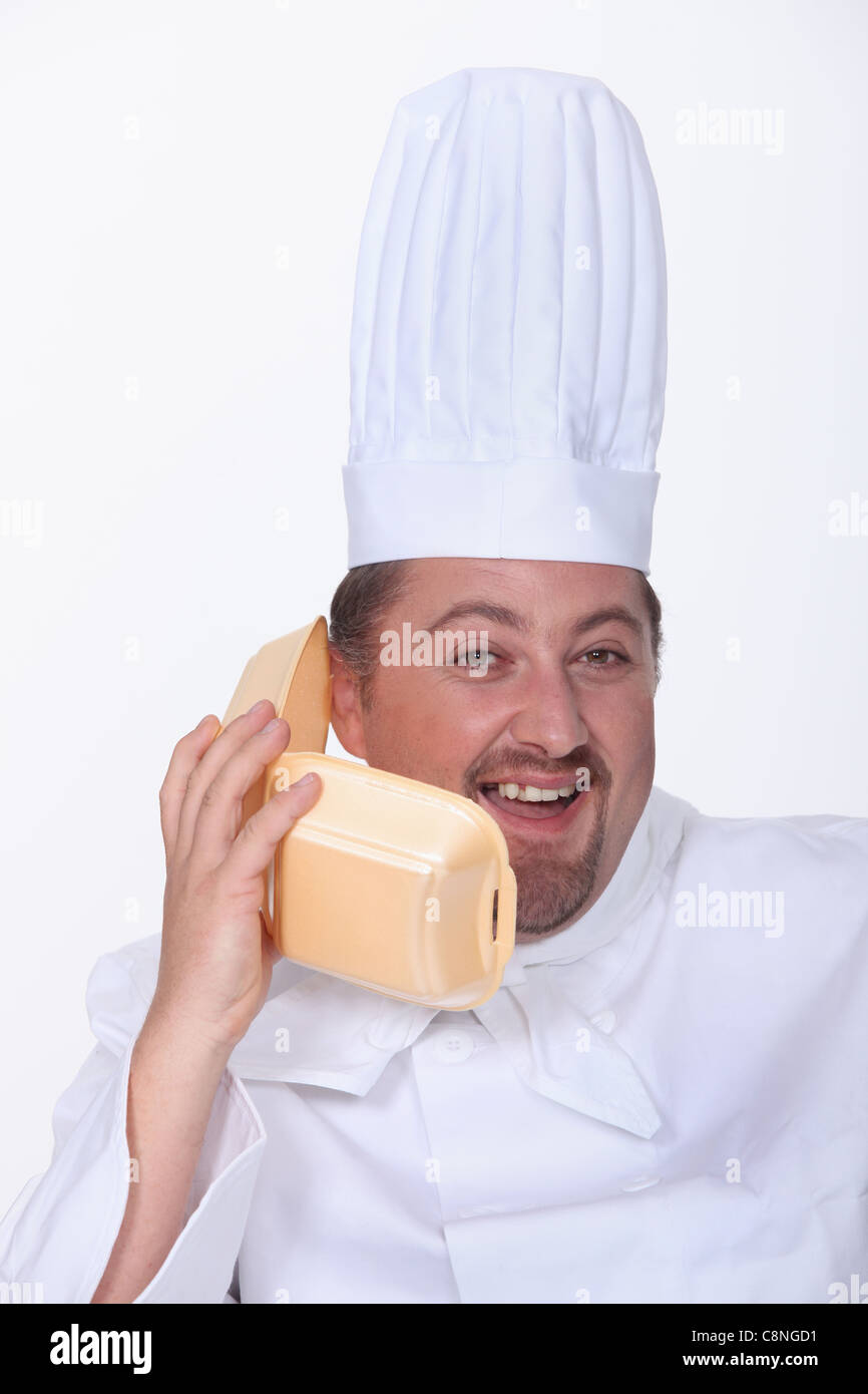 Chef talking into burger box Stock Photo - Alamy